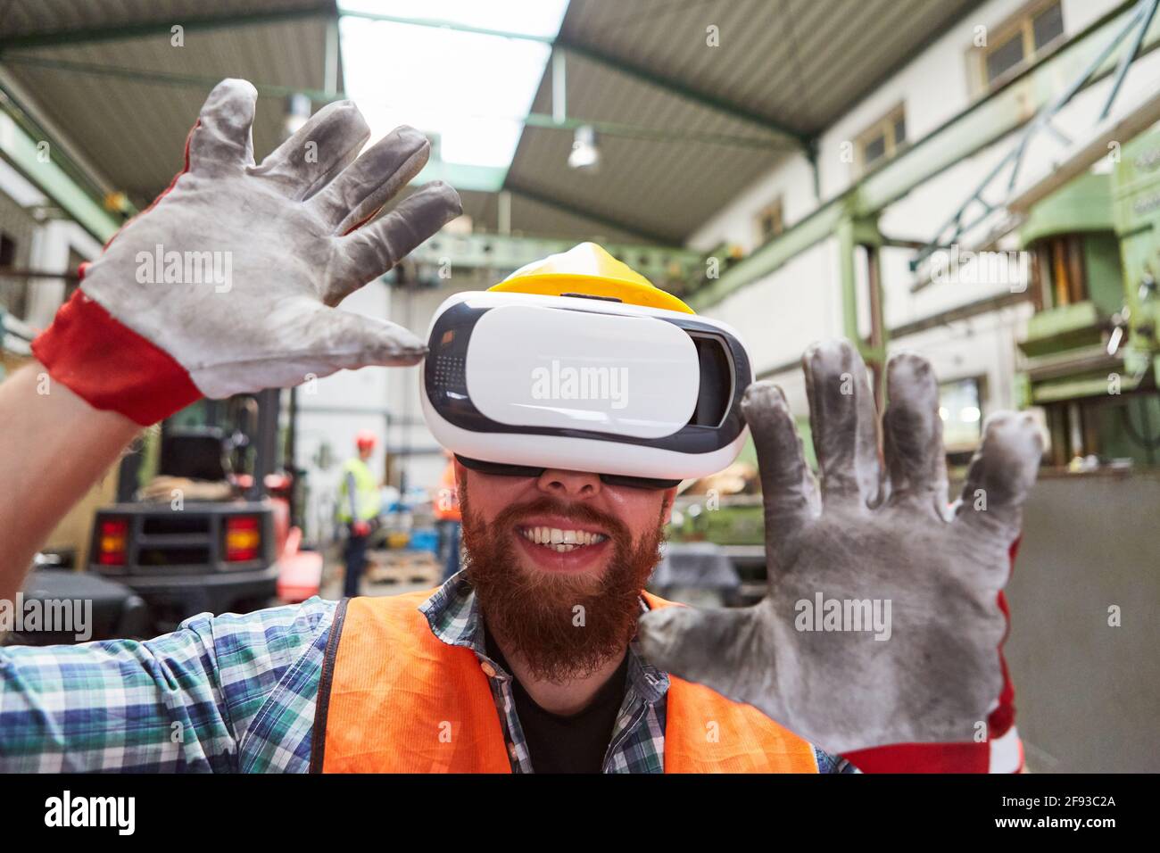 Workers with VR glasses in a factory hall while visualizing the ...