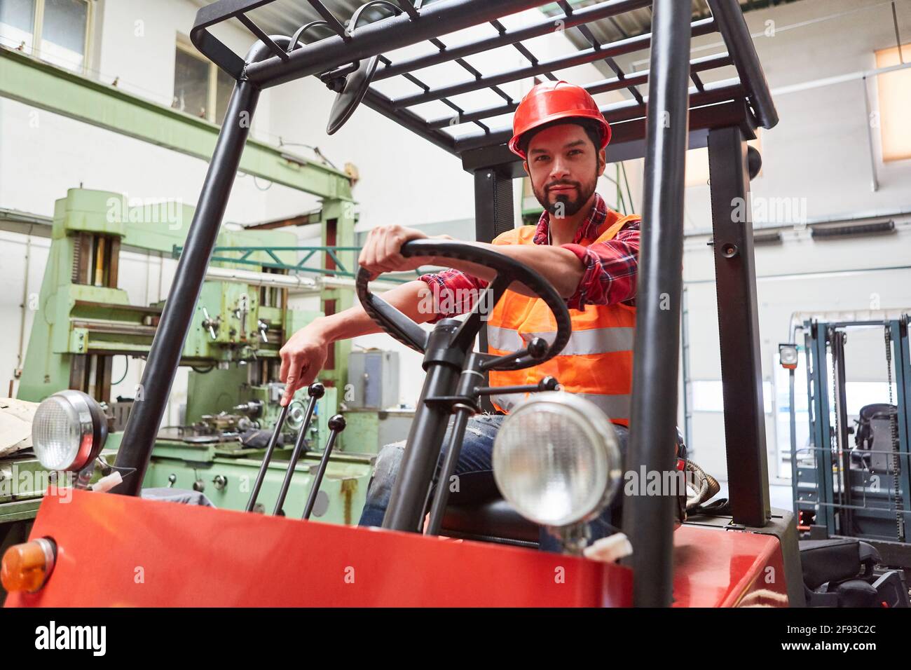 Worker as a forklift driver on the forklift in the warehouse of the ...