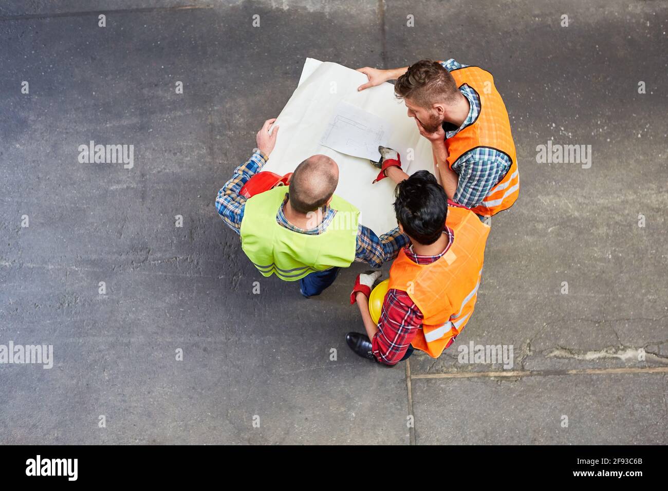 Group of workers with blueprint when planning from above on a ...