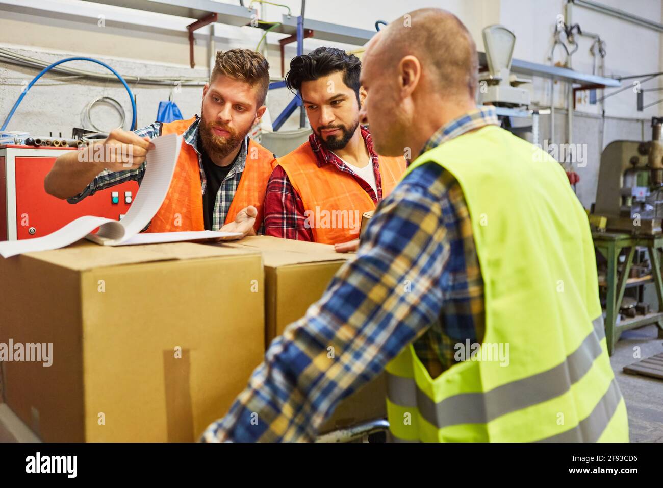 Order pickers and colleagues check cardboard boxes in shipping or ...