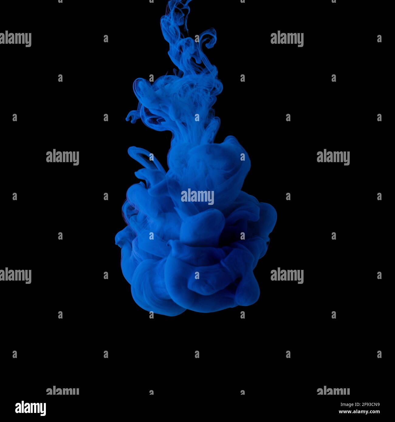 Explosion of colored, fluid and neoned liquids on black studio ...