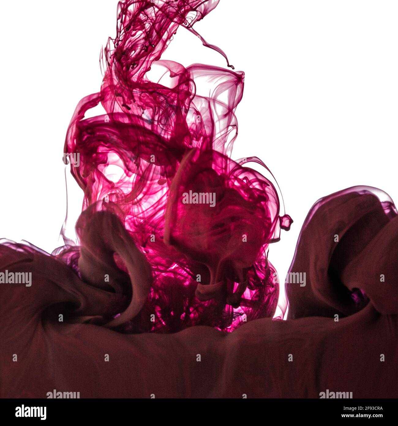 Explosion of colored, fluid and neoned liquids on white studio ...