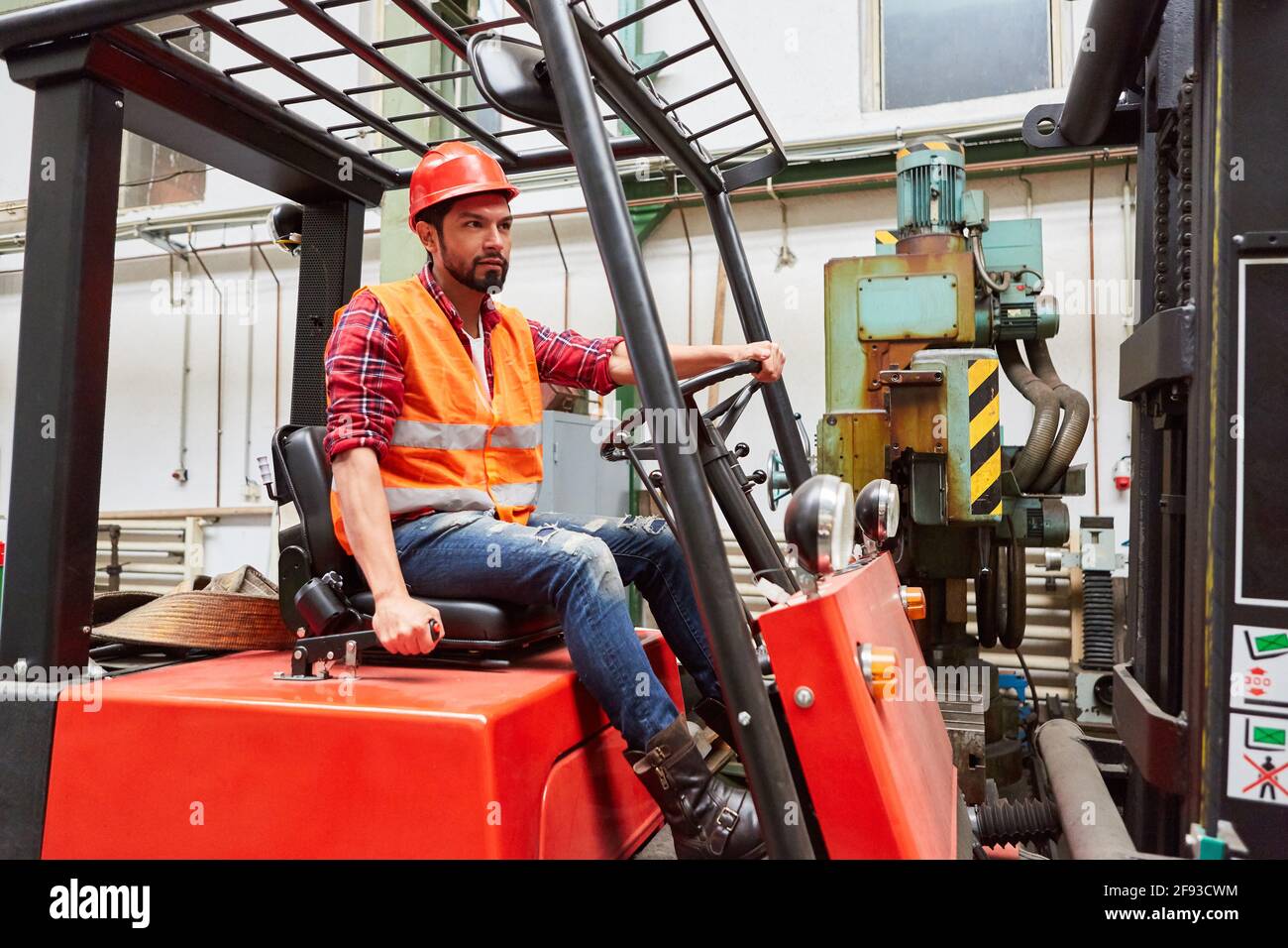 Forklift driver on the forklift in the warehouse during loading and ...