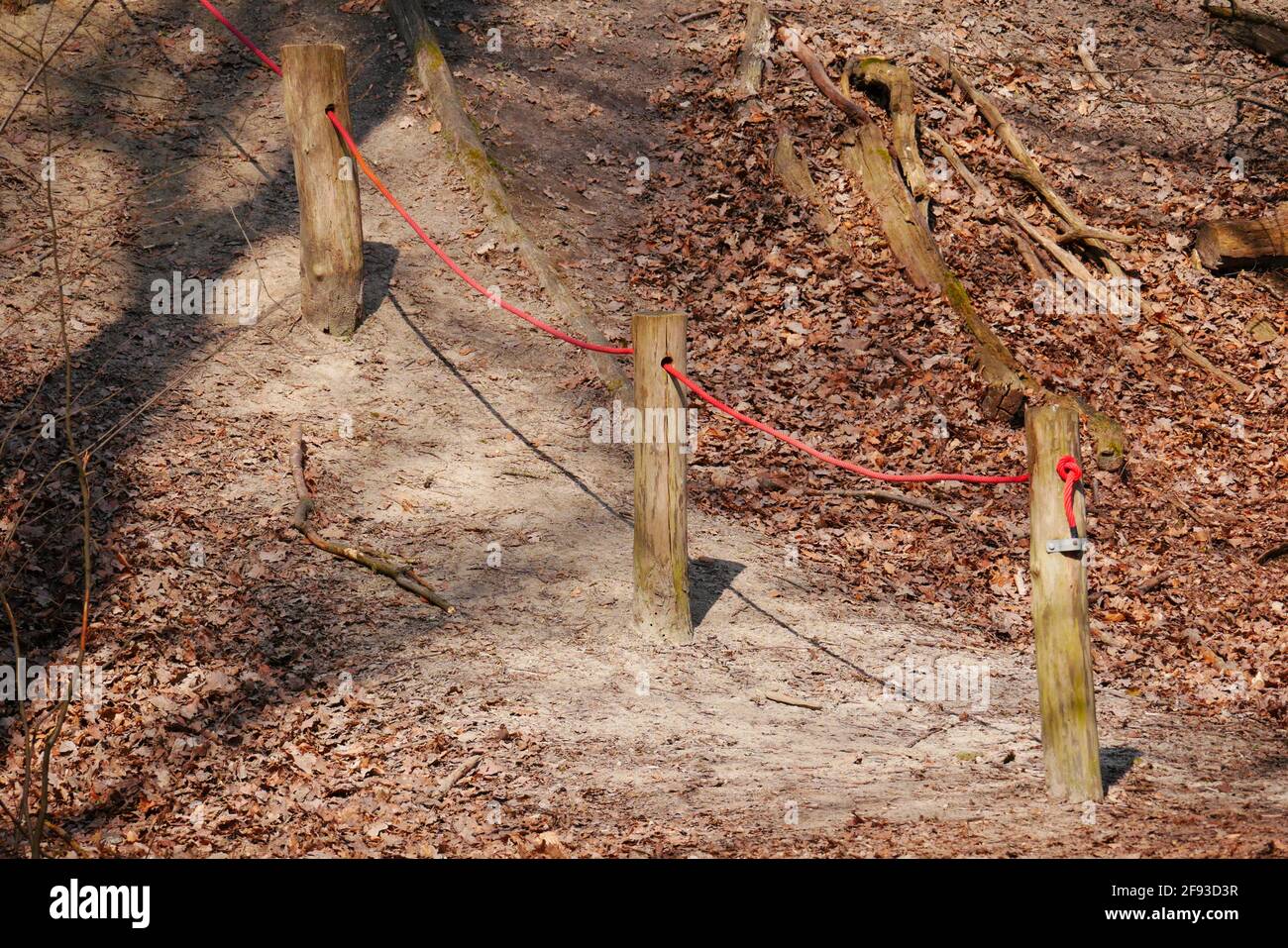 ascent of a hiking trail in the forest with a red rope ascent aid Stock ...