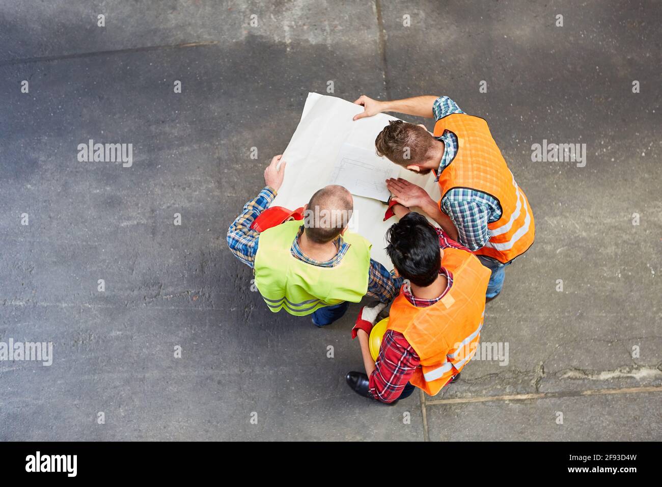 Group of workers with architectural drawing when planning on a ...