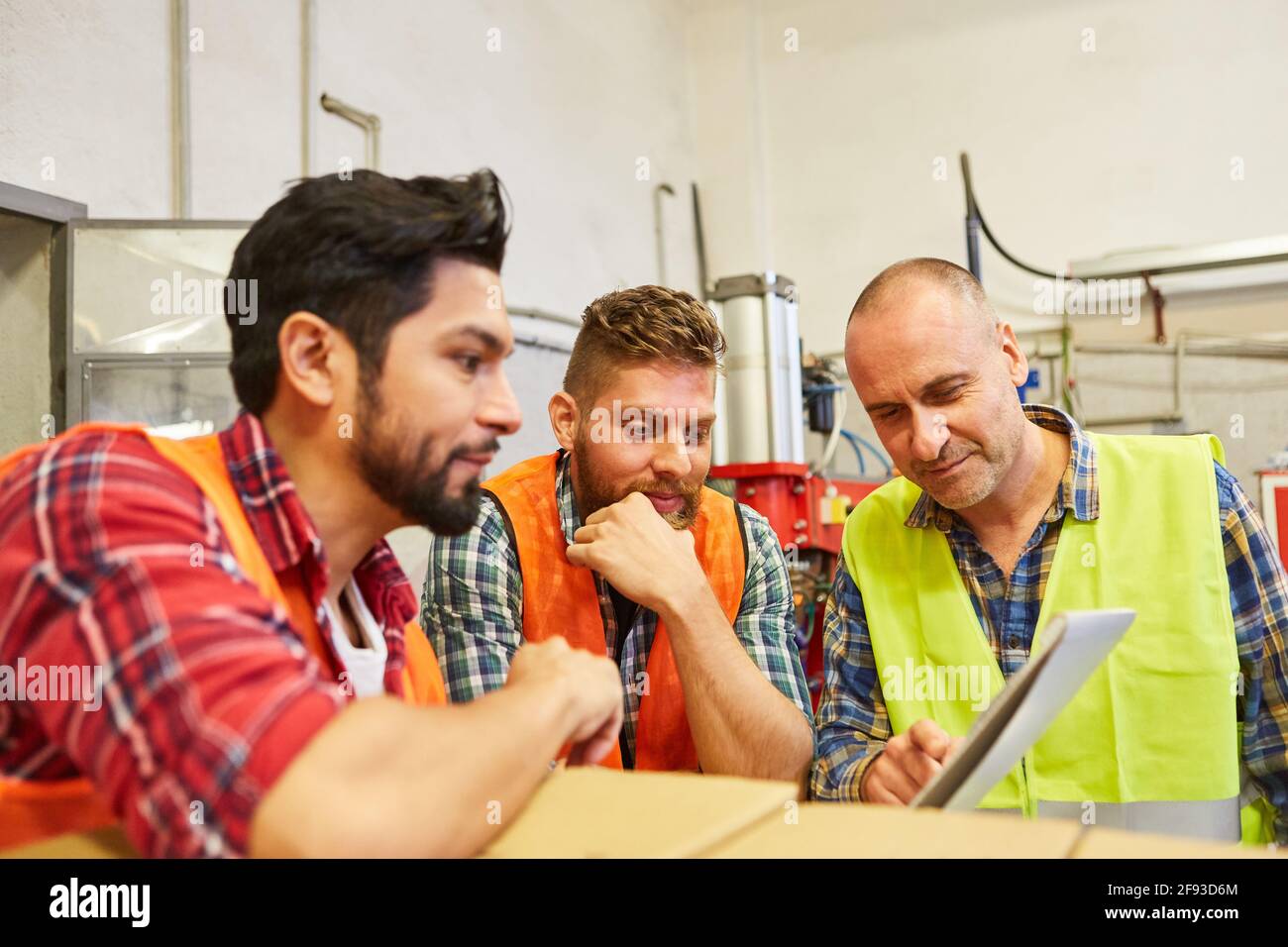 Warehouse workers and order pickers discuss an order in the factory ...