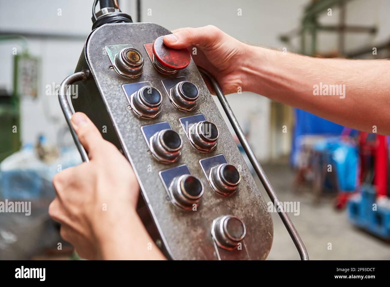 Hand operates buttons on the crane control or the control panel of a ...