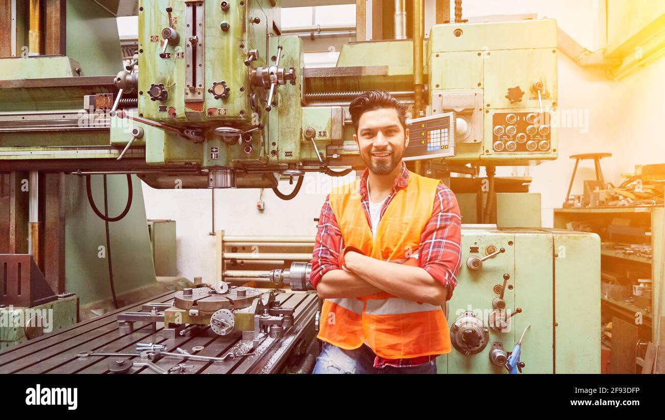 Metal worker at CNC drilling machine in metal processing factory Stock ...