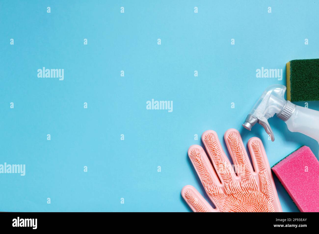 Cleaning supplies collection on blue background. Housework concept ...