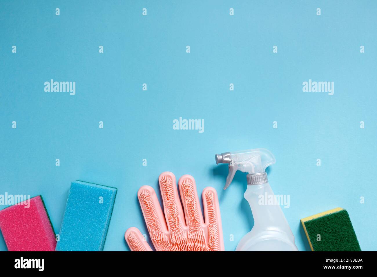 Cleaning supplies collection on blue background. Housework concept ...