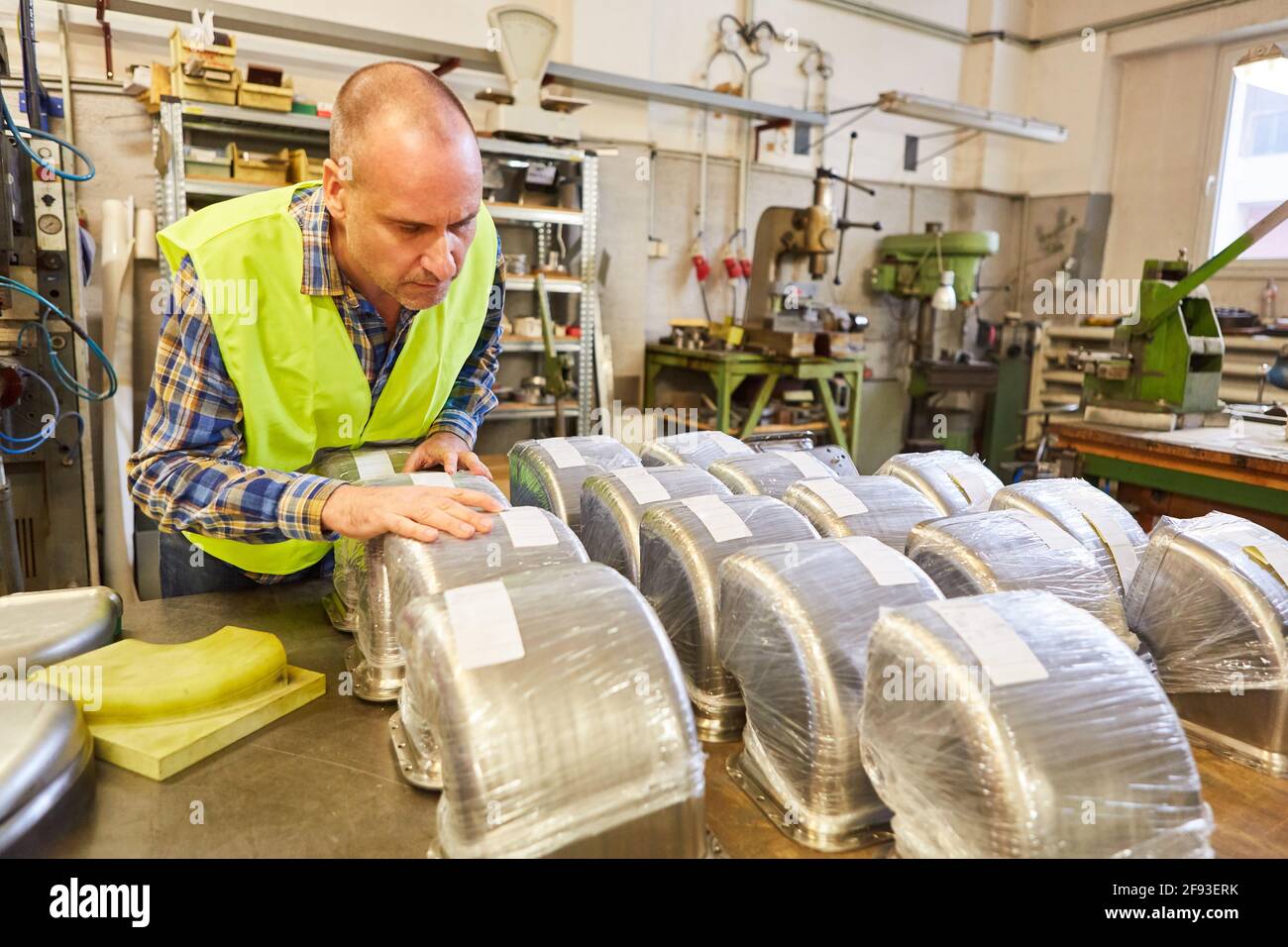 Metal worker controls the quality of production and material in a metal ...