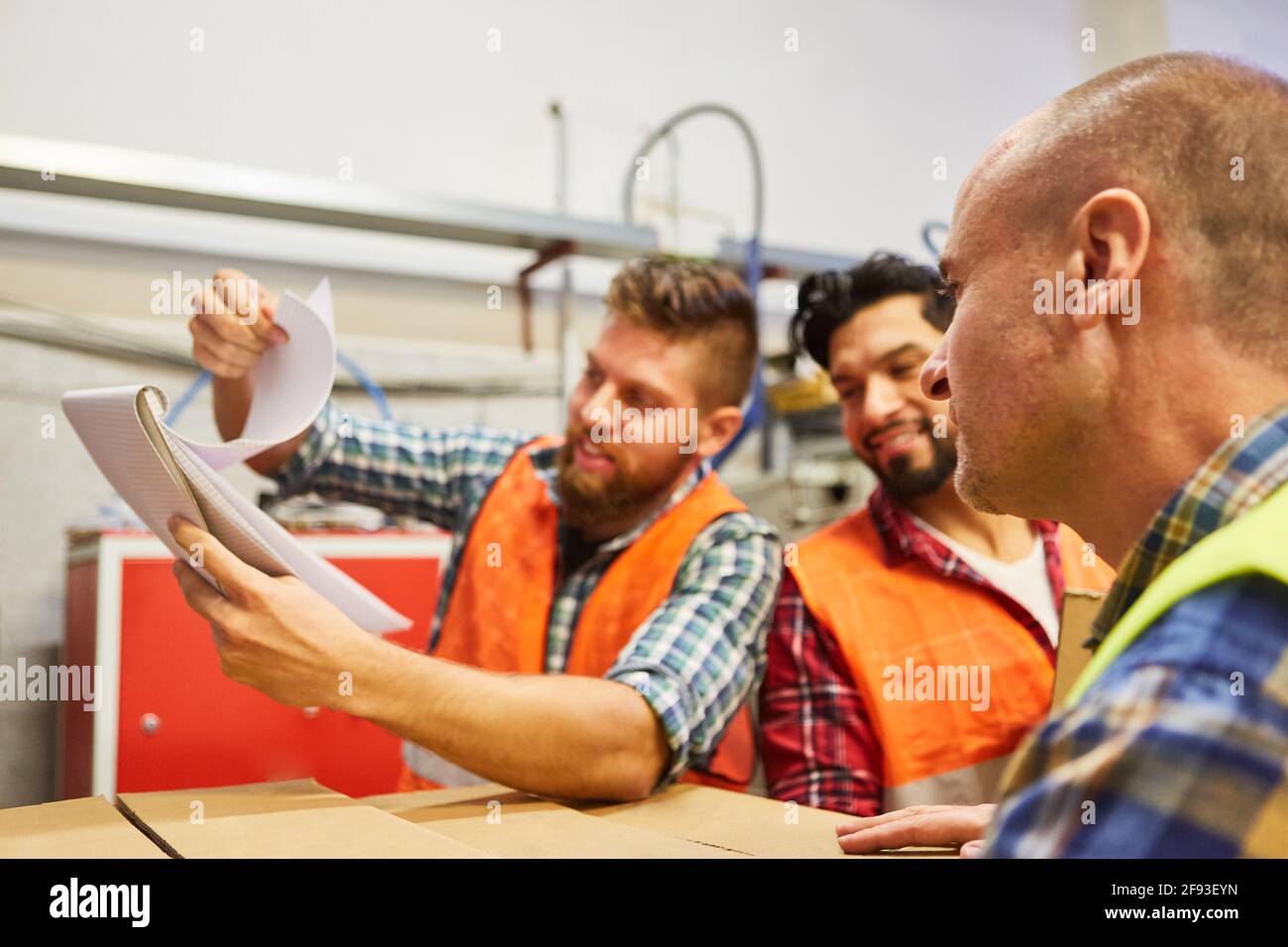 Warehouse workers and order pickers check orders in the incoming goods ...