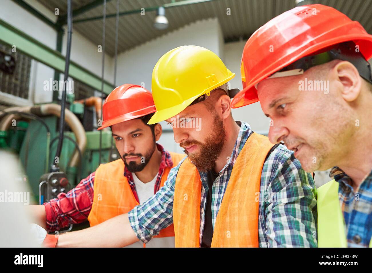 Group of craftsmen and metal workers planning in teamwork in the metal ...