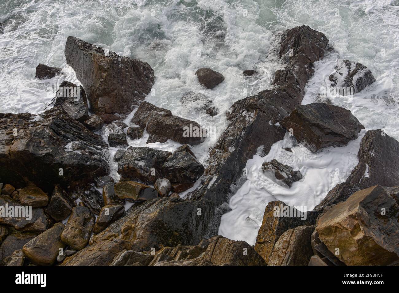 Waves crash against the rocky shores of the Basque coast. San Sebastian ...