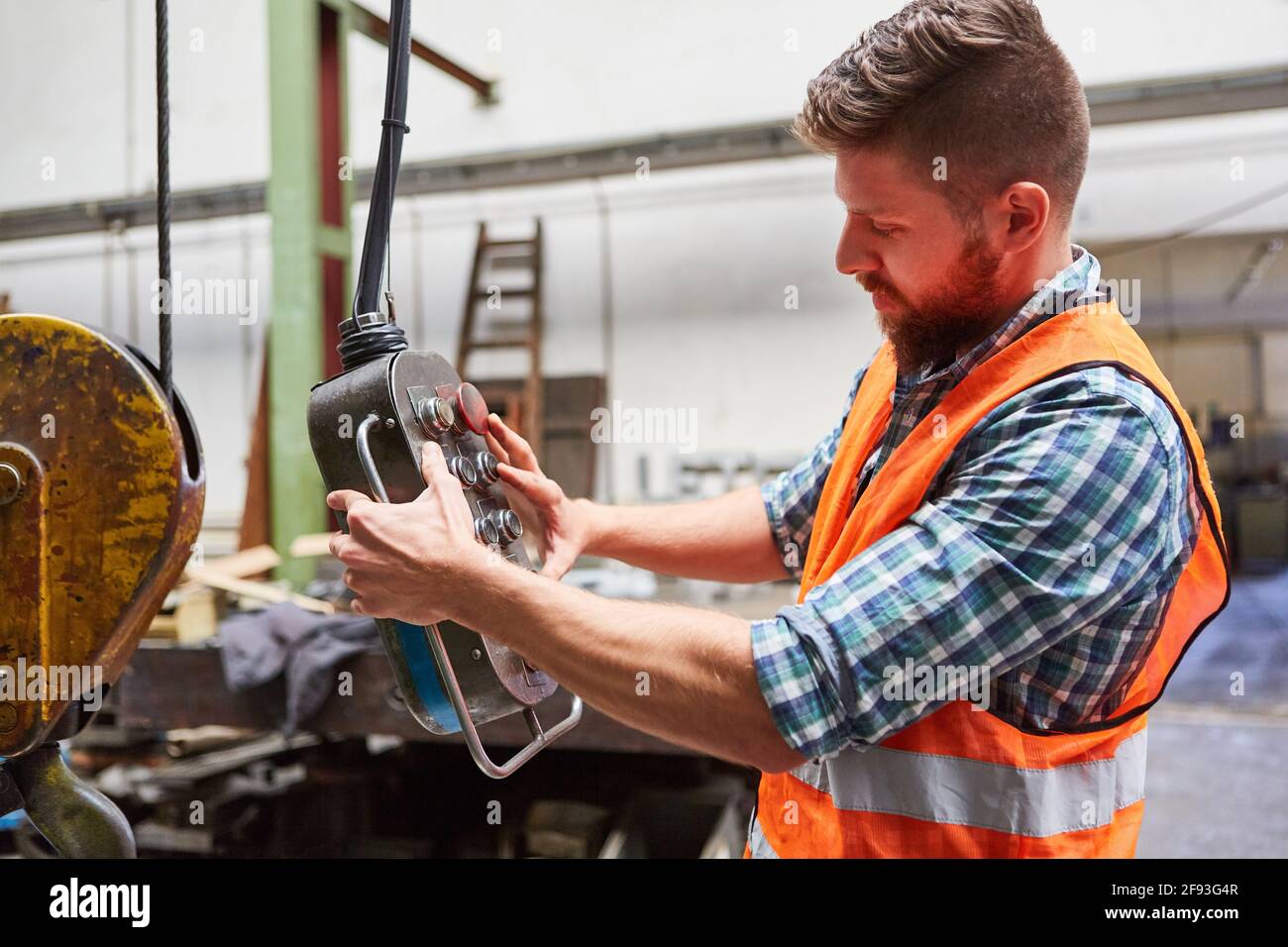 Man as a skilled worker in the metalworking factory at the control ...