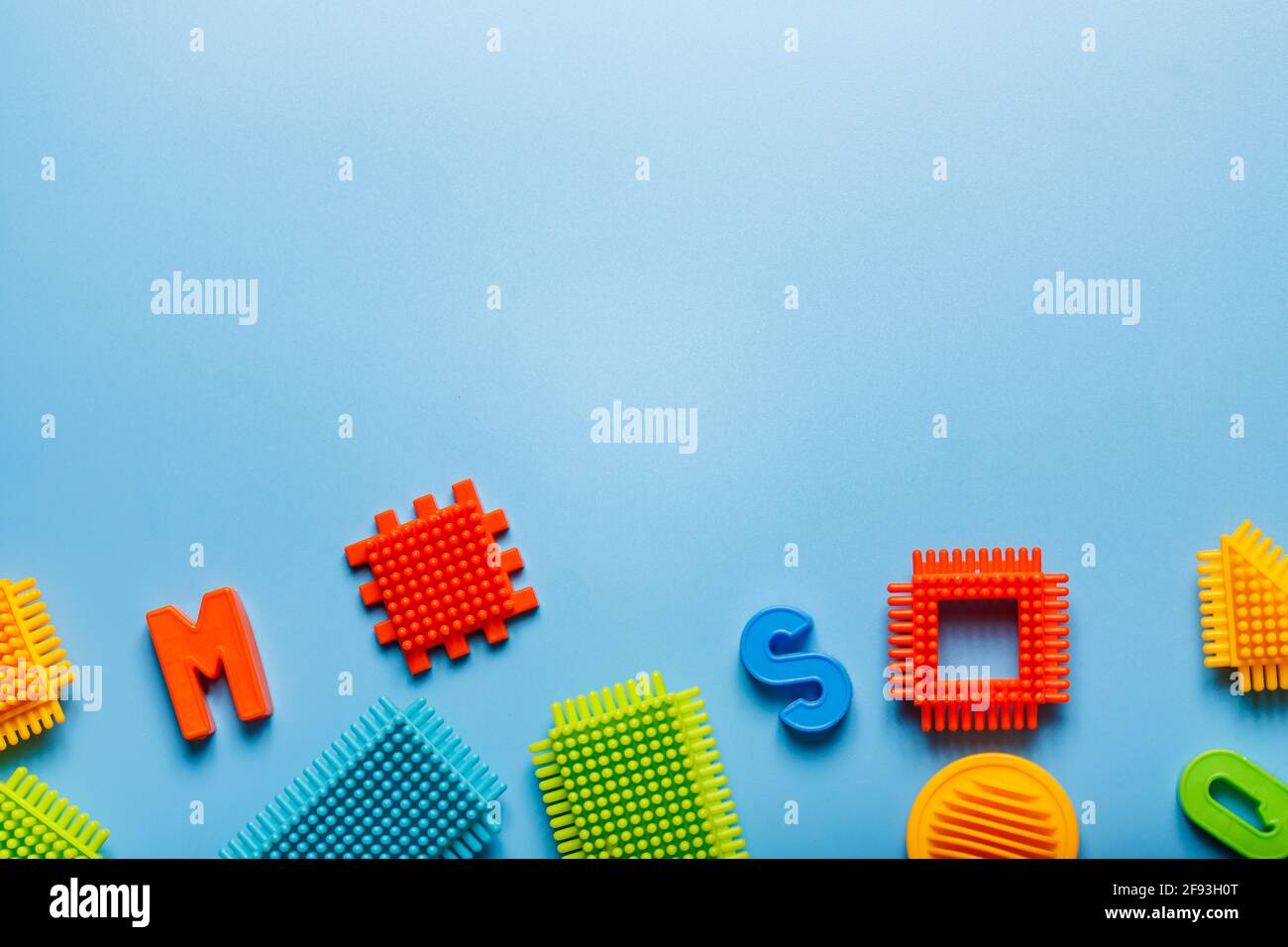 Colorful kids blocks on blue background. Top view Stock Photo - Alamy