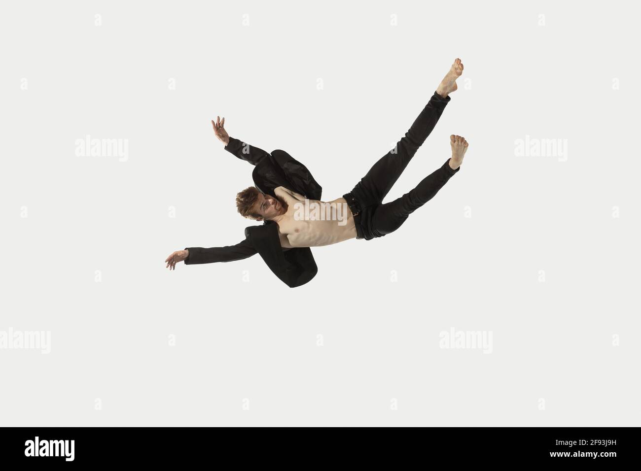 Man in casual style clothes jumping and dancing isolated on white ...