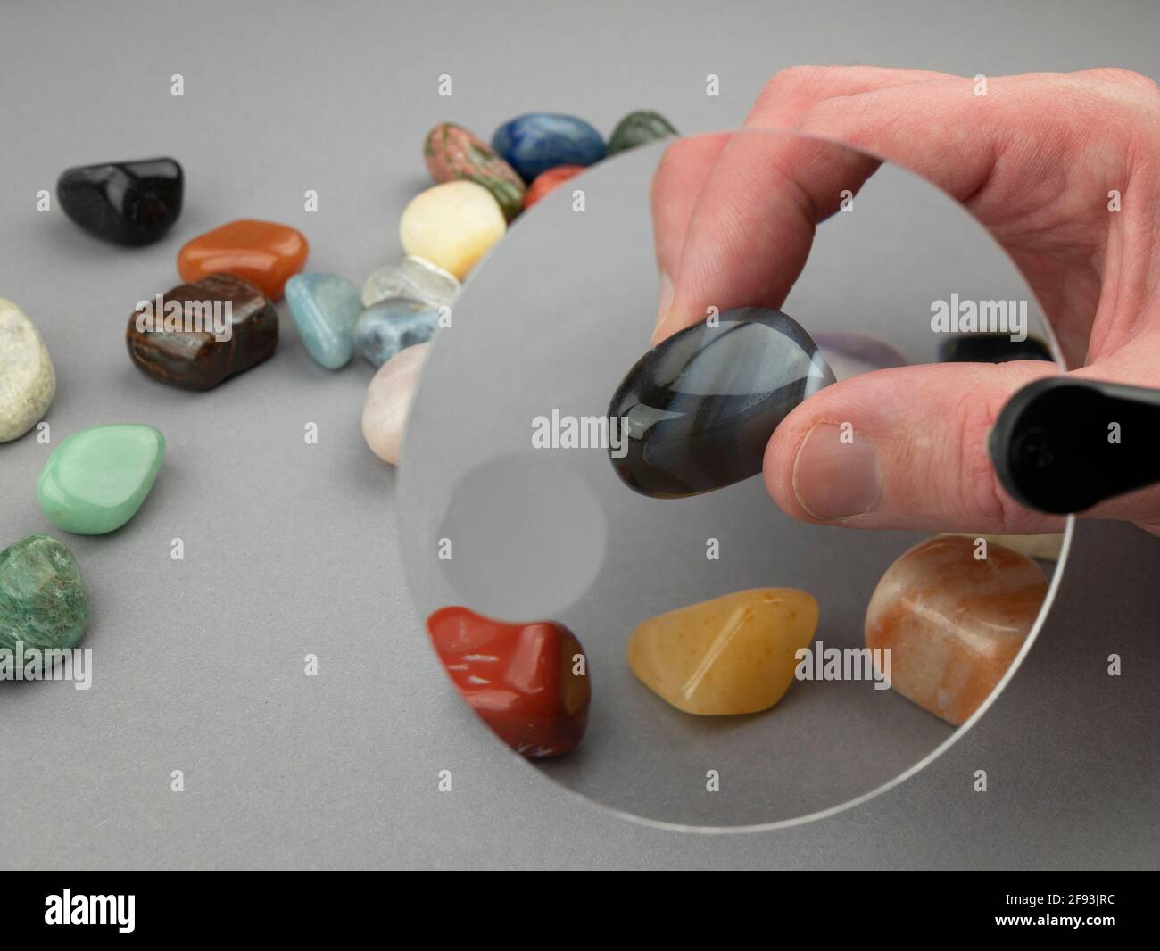 Exploring semi-precious stones with a loupe. Colored gemstones under ...