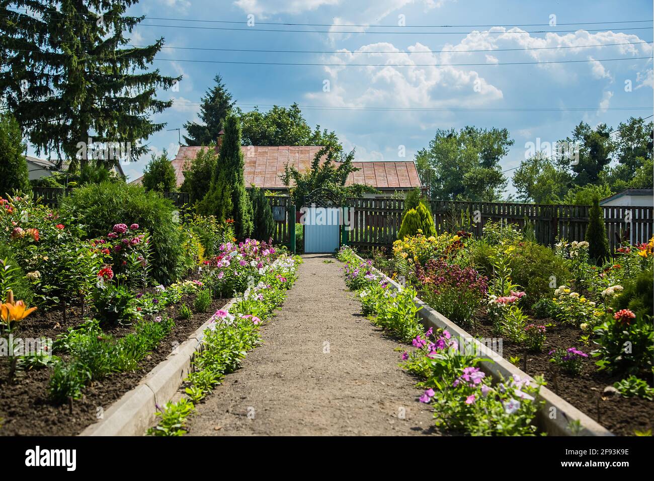 Flower garden houseHouse of a flower garden. Bushes of roses, lilies ...