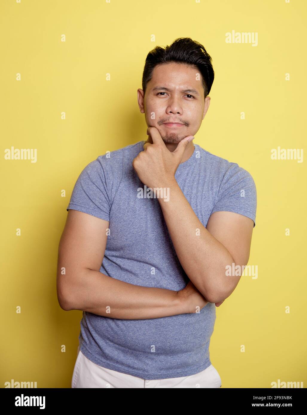 casual young man smile thinking idea with holding the chin and one hand ...