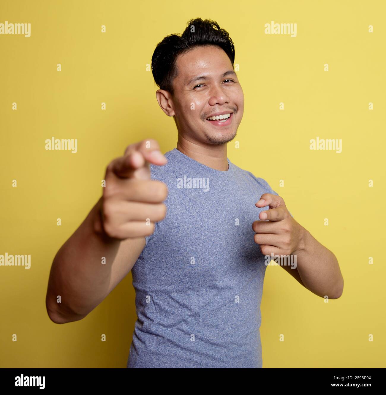 casual young man pointing the camera very happy Stock Photo - Alamy