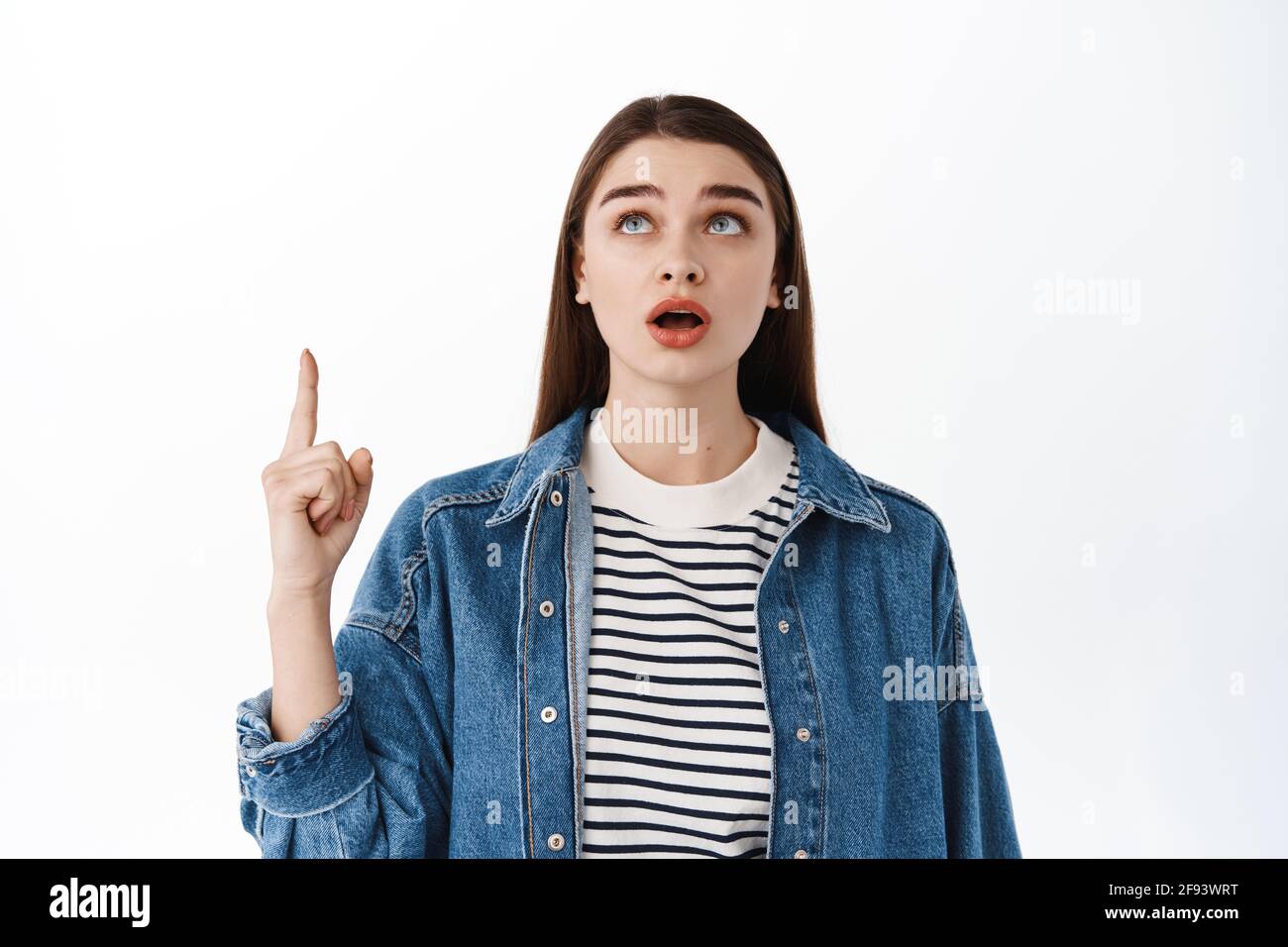 Wow look up. Impressed young woman drop jaw, gasping fascinated ...