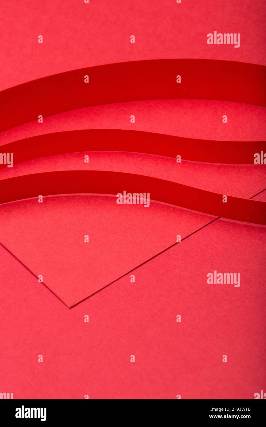 Abstract minimal paper background. Red cut out curvy paper stripes on ...
