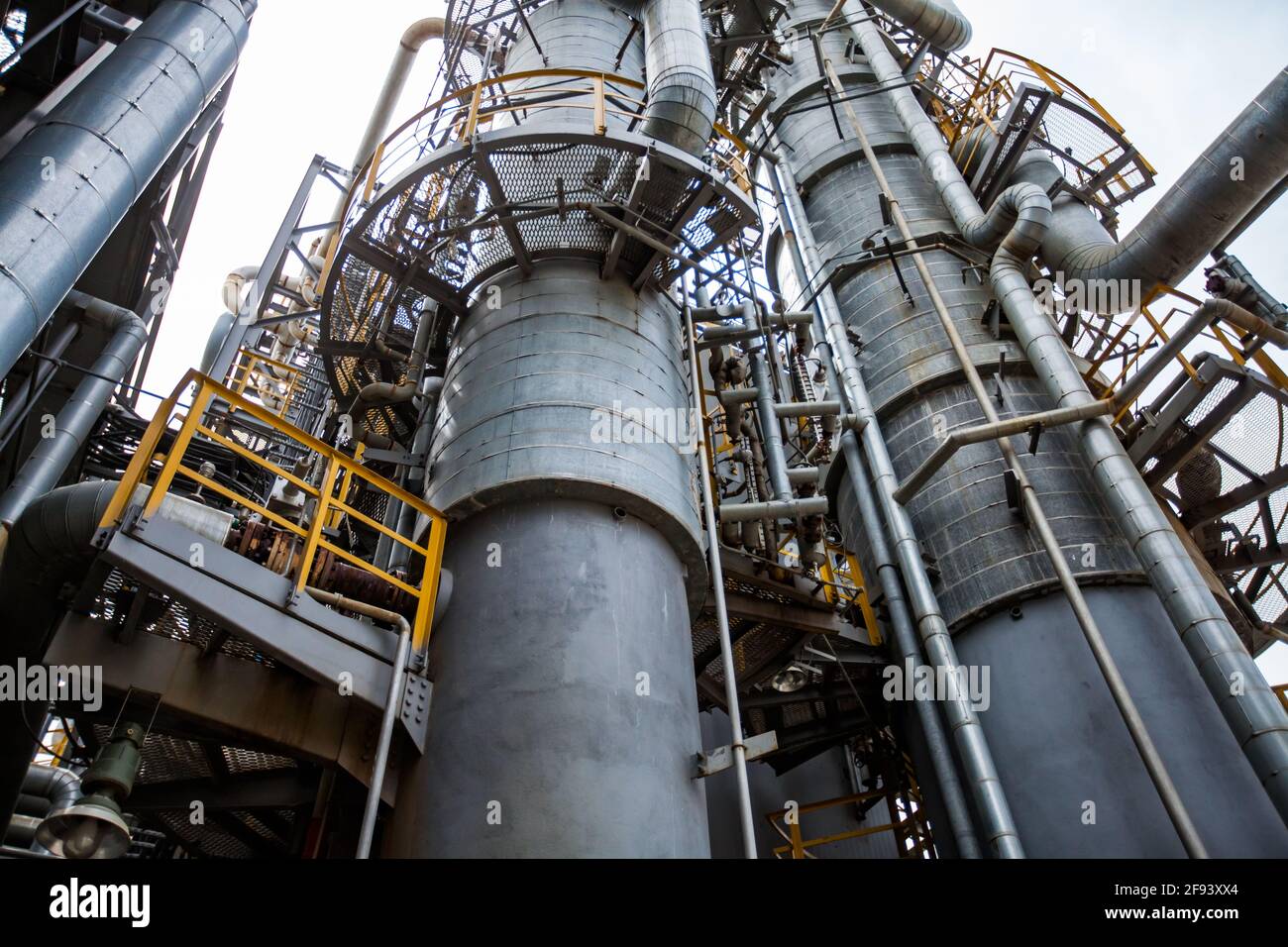 Close-up of distillation column on blue sky with sun background. Oil ...