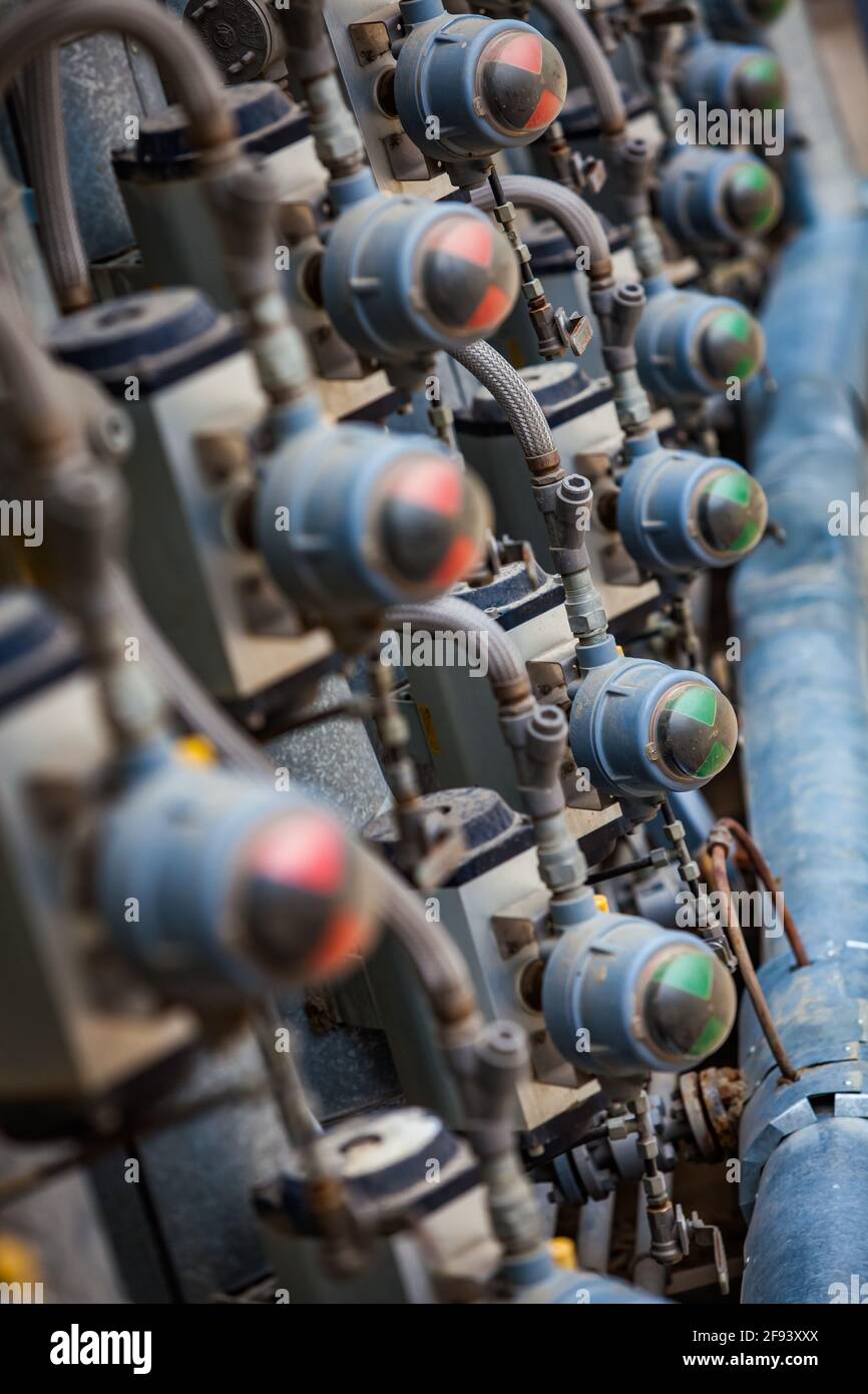 Oil refinery plant.. Valve position monitors on pipes. Focus on ...