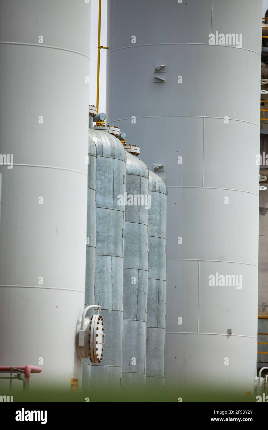 Close-up of white and galvanized tanks. Oil refinery plant (refining ...