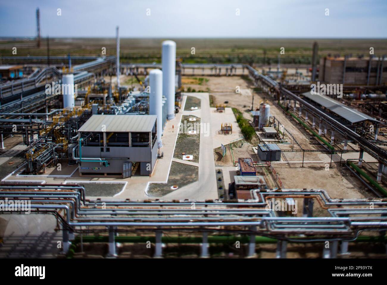 Oil refinery plant. Tilt-shift view. Partially blurred. White tanks and ...