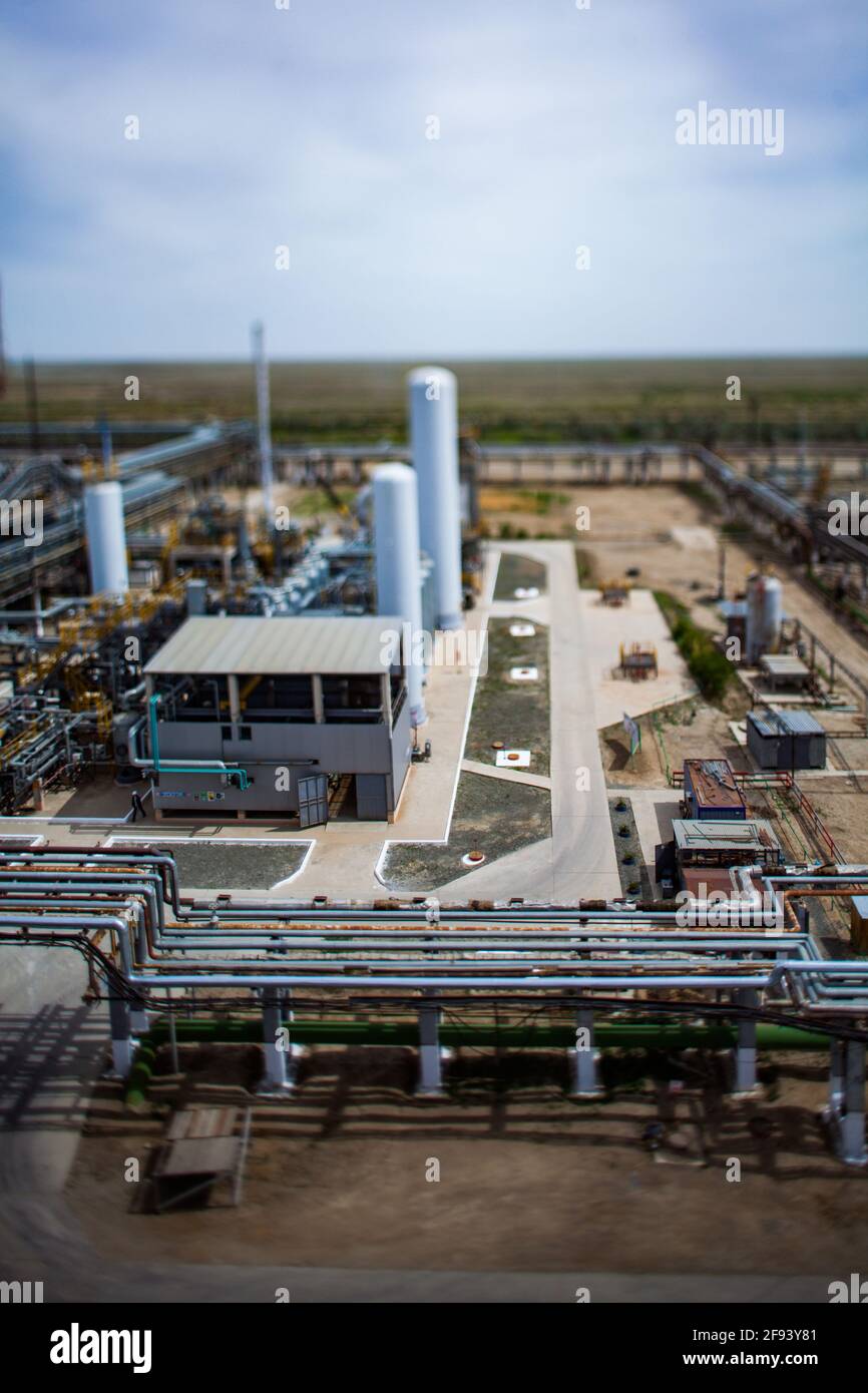 Oil refinery plant. Tilt-shift view. Partially blurred. White tanks and ...