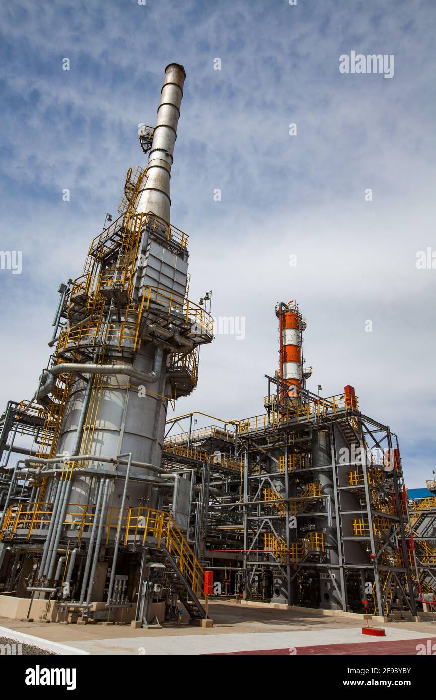 Oil refinery plant in desert on blue sky with clouds. Distillation ...