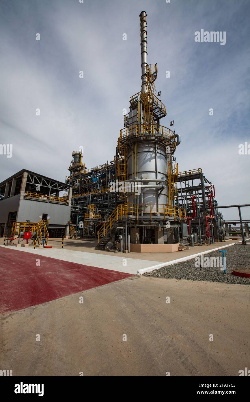 Distillation column and pipelines.Oil refinery plant in desert. On blue ...