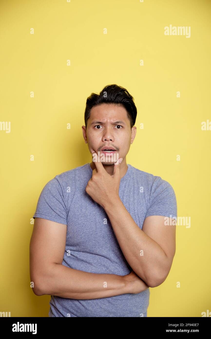 casual young man smile thinking idea with holding the chin and one hand ...