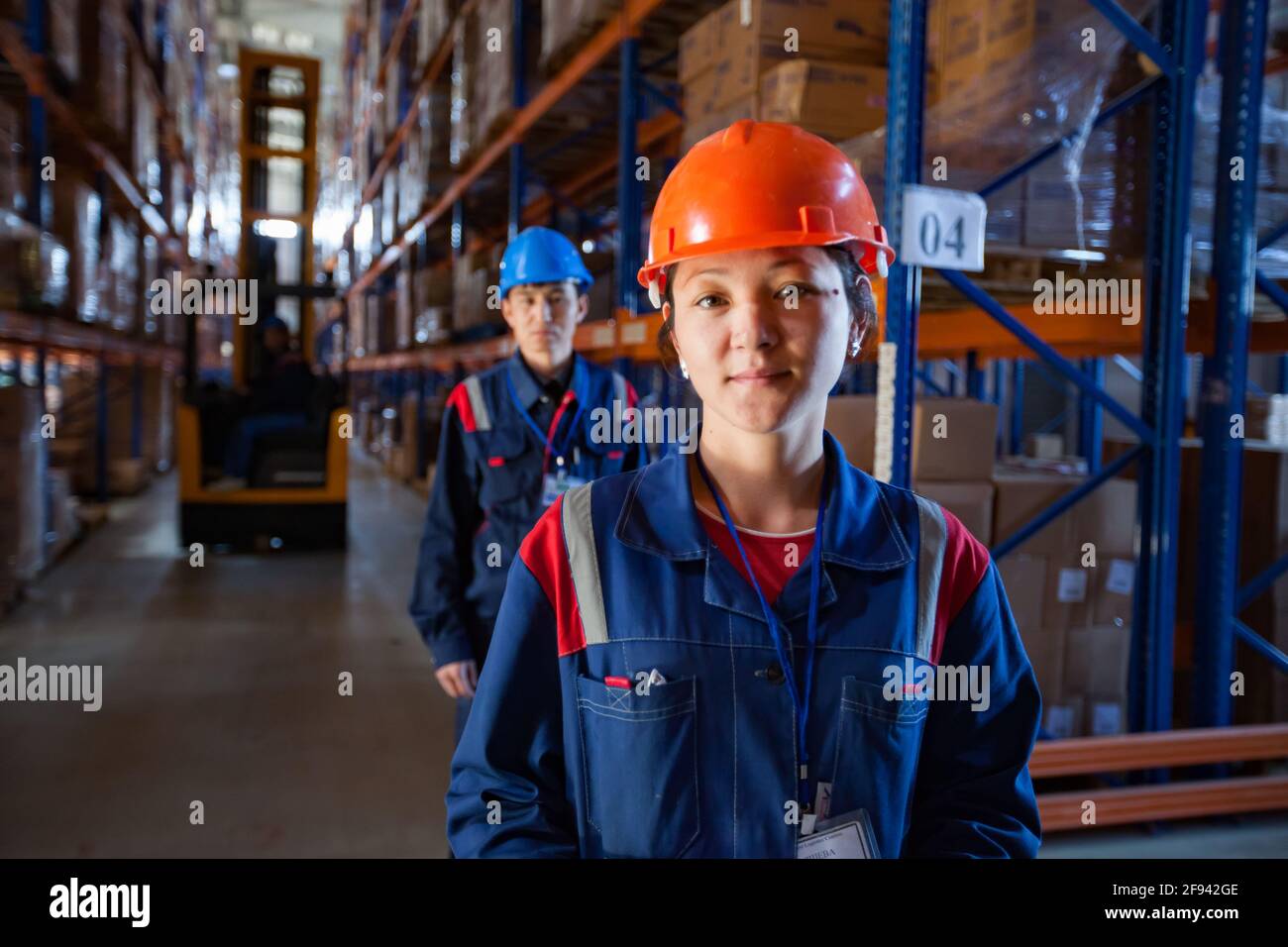 Modern distribution centre and warehouse. Two young Asian operators in ...