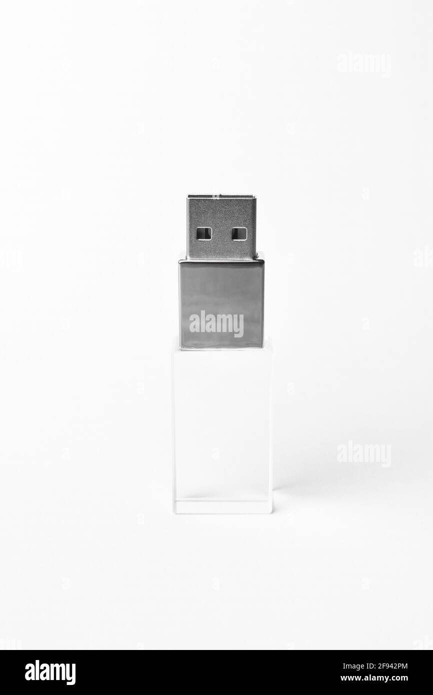Vertical glass transparent USB drive with metal insert isolated on grey ...