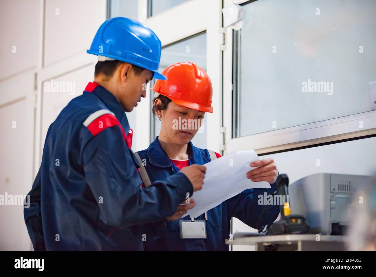 Modern logistic centre and warehouse. Two young operators reading ...