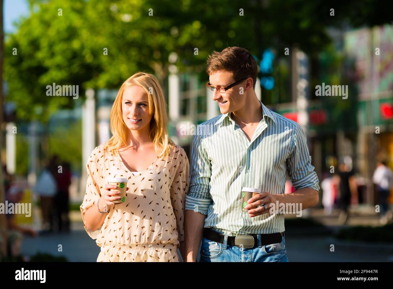 Couple enjoying coffee in the lunch break at walk in the sun Stock ...