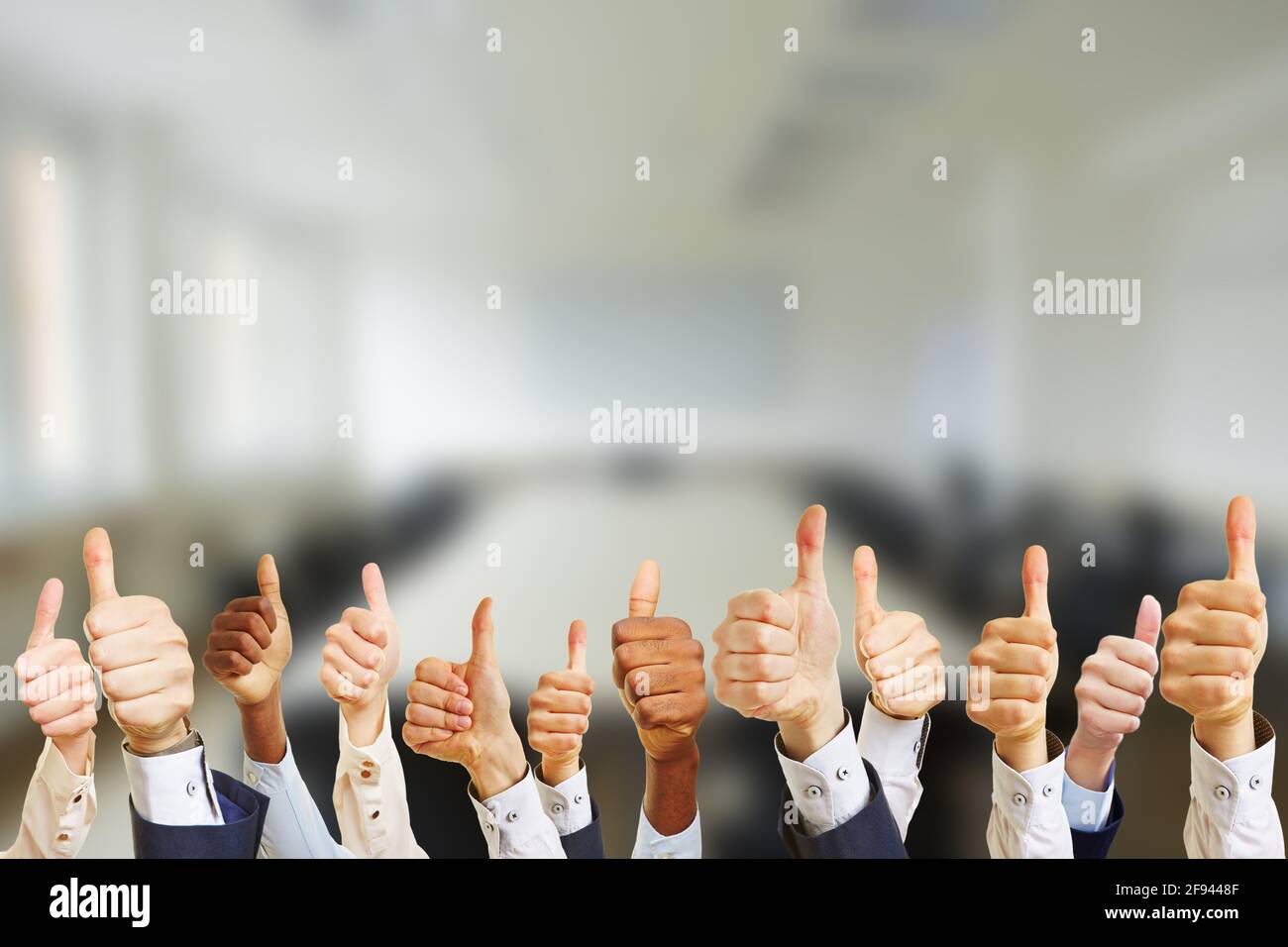 Business team holds thumbs up at work Stock Photo - Alamy