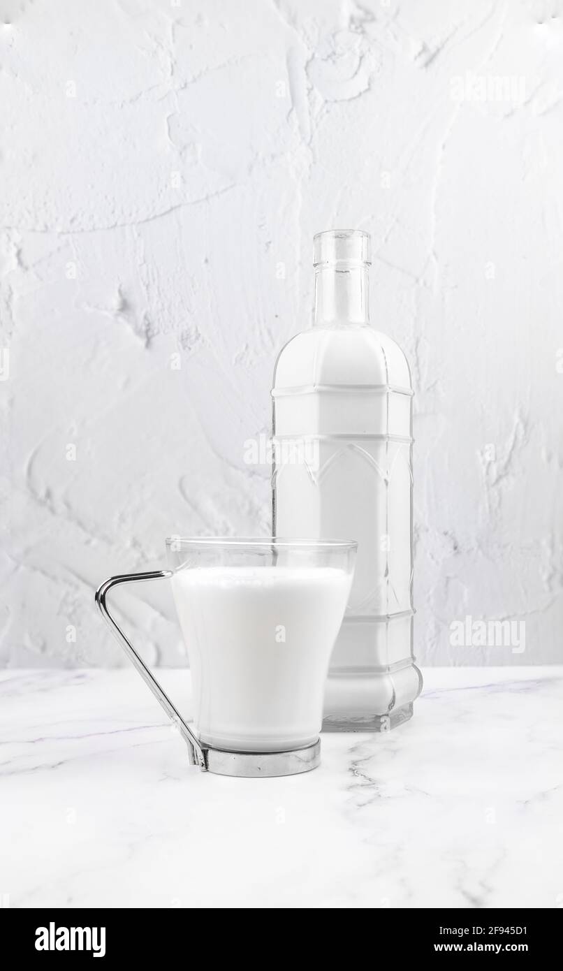 Glass mug along with a bottle filled with milk. World milk day. Healthy ...