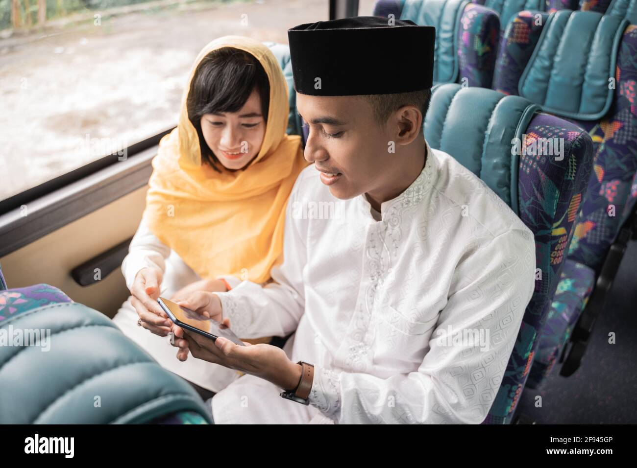 muslim couple travel by bus during eid mubarak holiday Stock Photo - Alamy