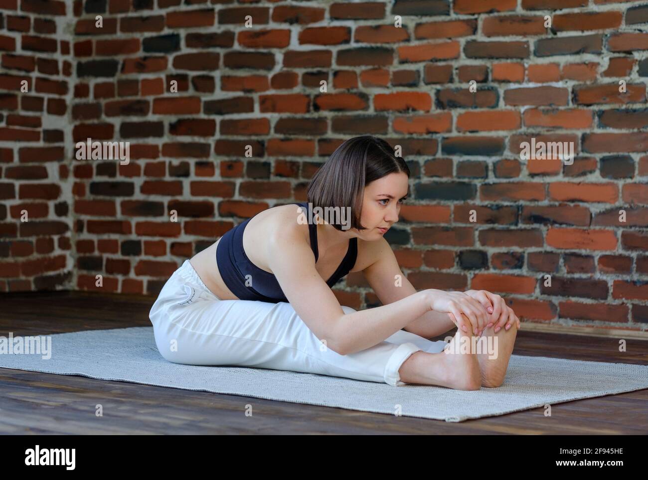Seated forward bend paschimottanasana hi-res stock photography and ...