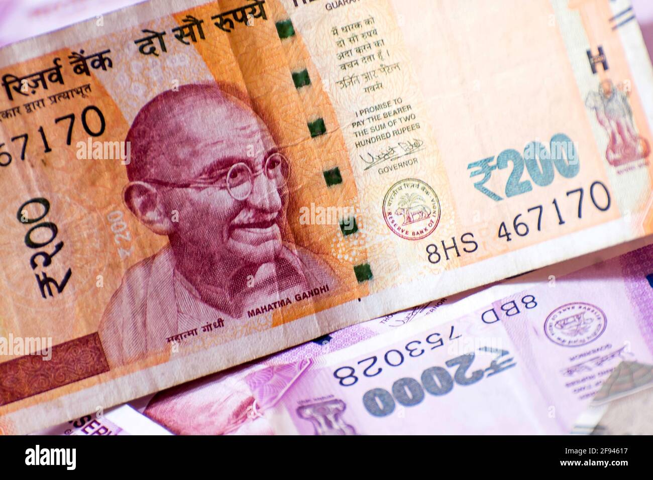 Close-up of Indian two hundred rupees against Indian paper currency ...