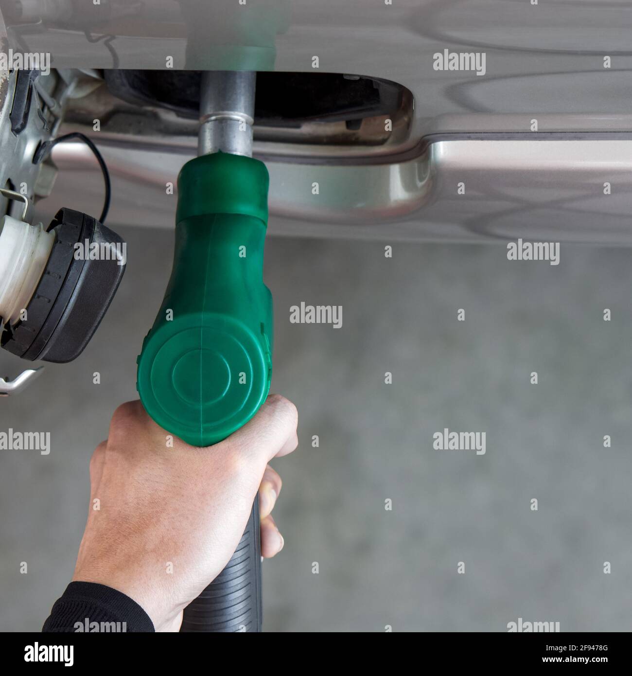 Gas station worker filling up bronze pickup truck tank (Top View ...