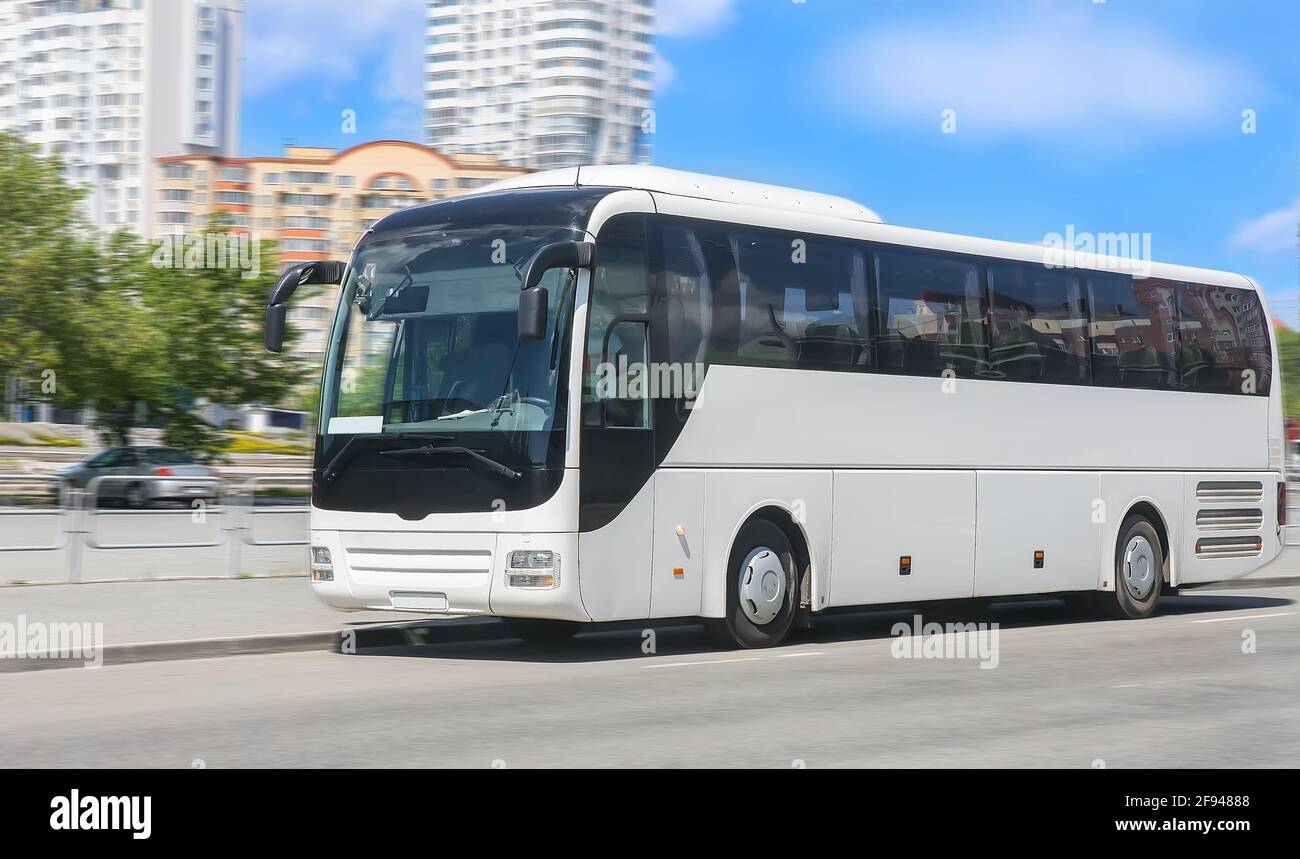 tourist bus is moving down the street in the city Stock Photo - Alamy
