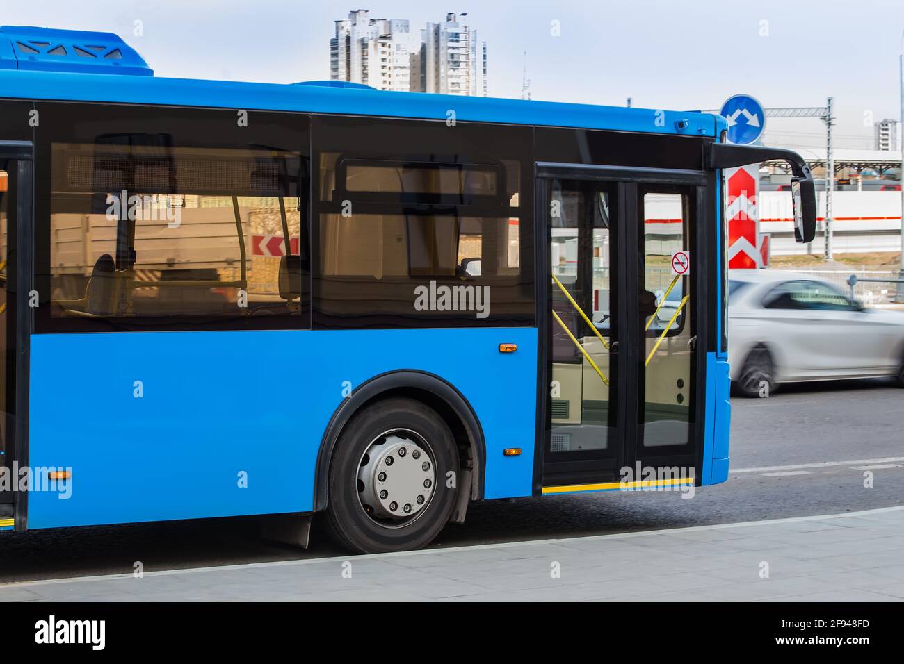 white city bus goes along street Stock Photo - Alamy