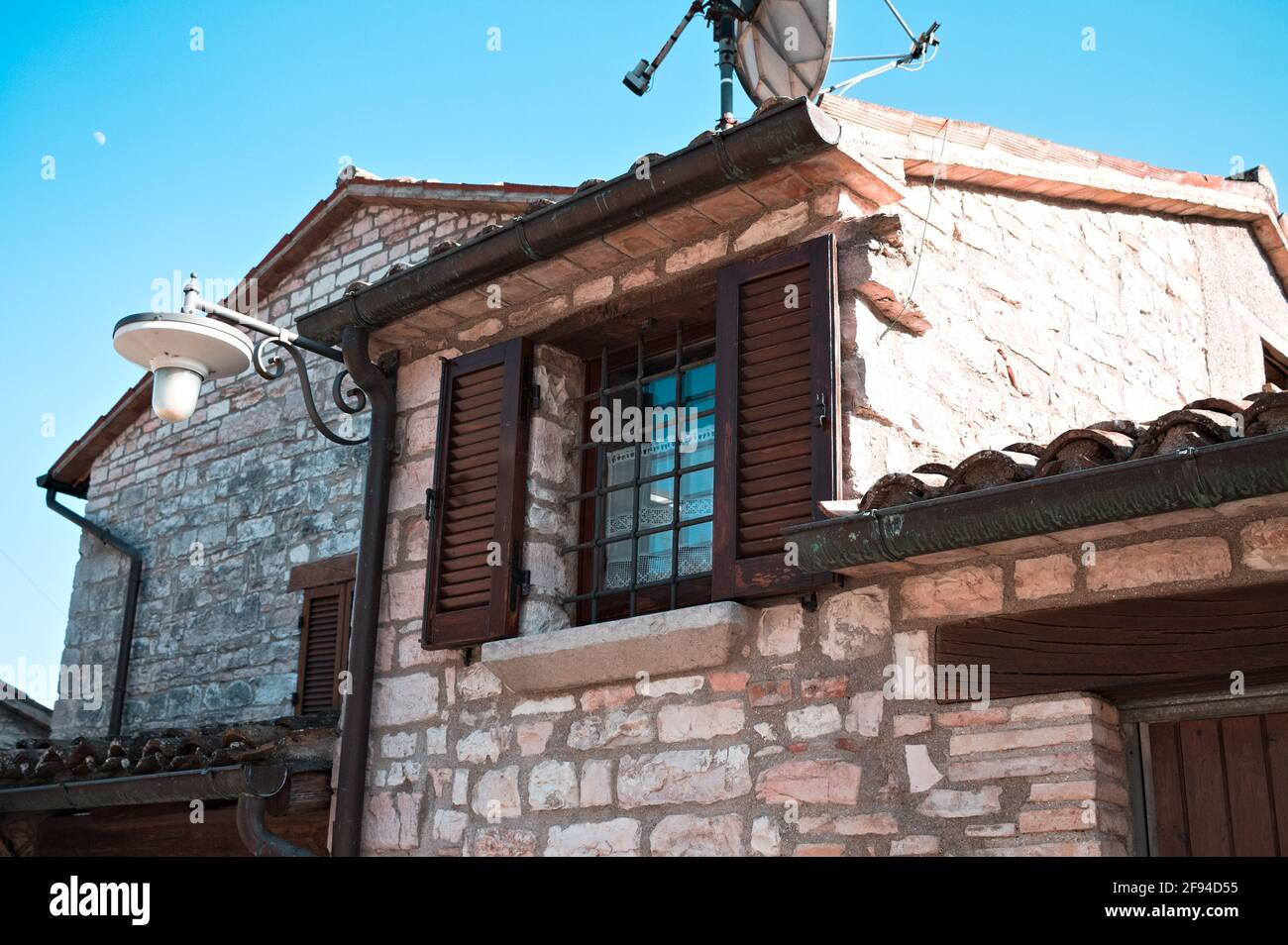 A window with wooden shutters in a medieval stone house (Marche, Italy ...