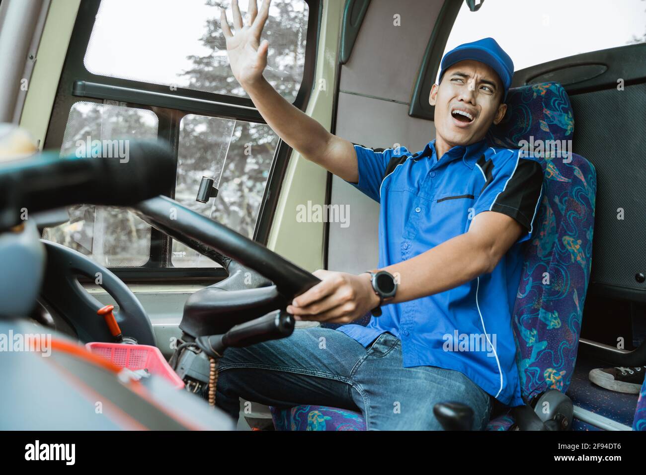 A Male Bus Driver In Blue Uniform With A Crashing Expression Stock a-male-bus-driver-in-blue-uniform-with-a-crashing-expression-stock