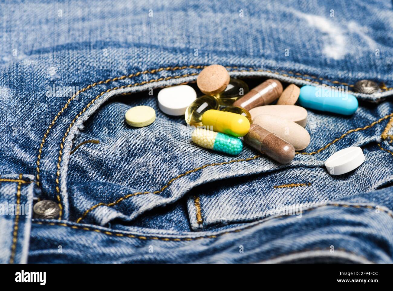 Drugs on denim background. Mixing medicines. Fast treatment. Medicine ...